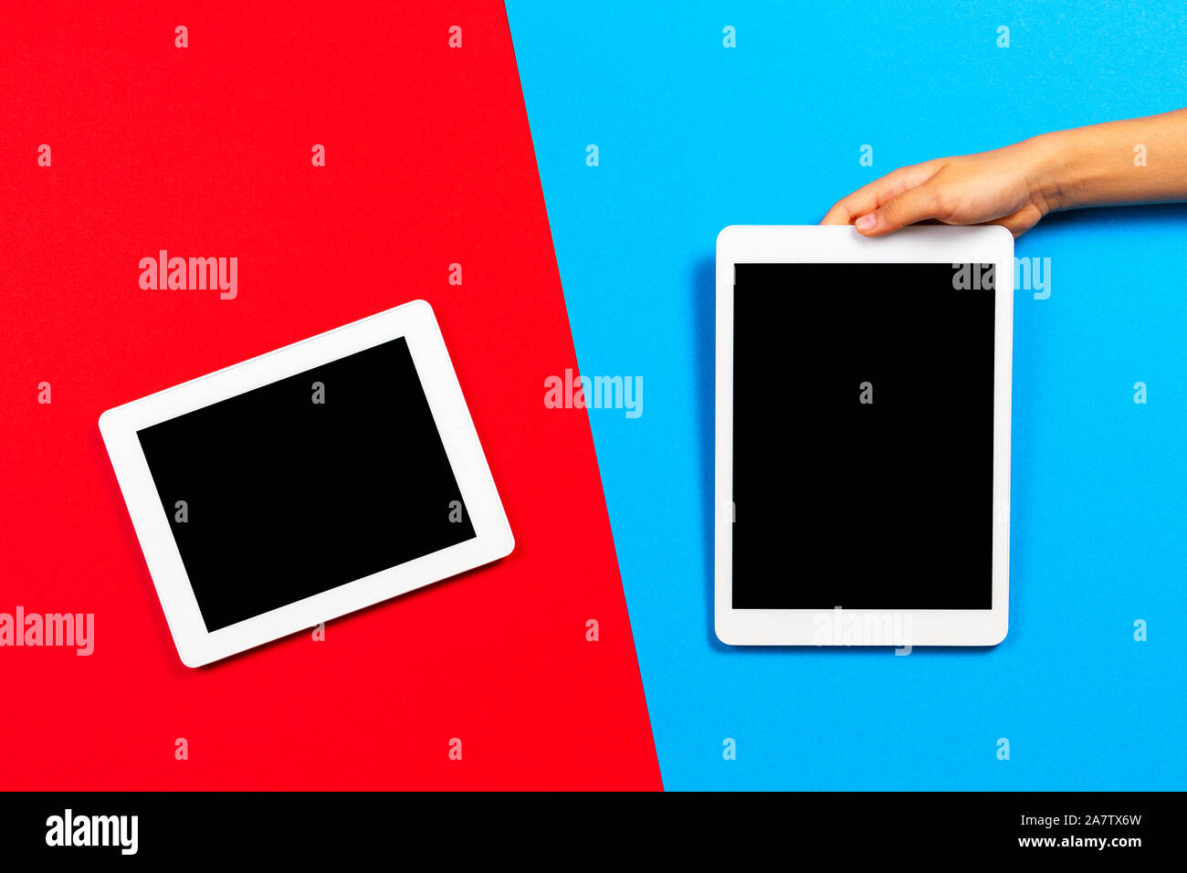 Kid hand with tablet computer on red and light blue background Stock ...