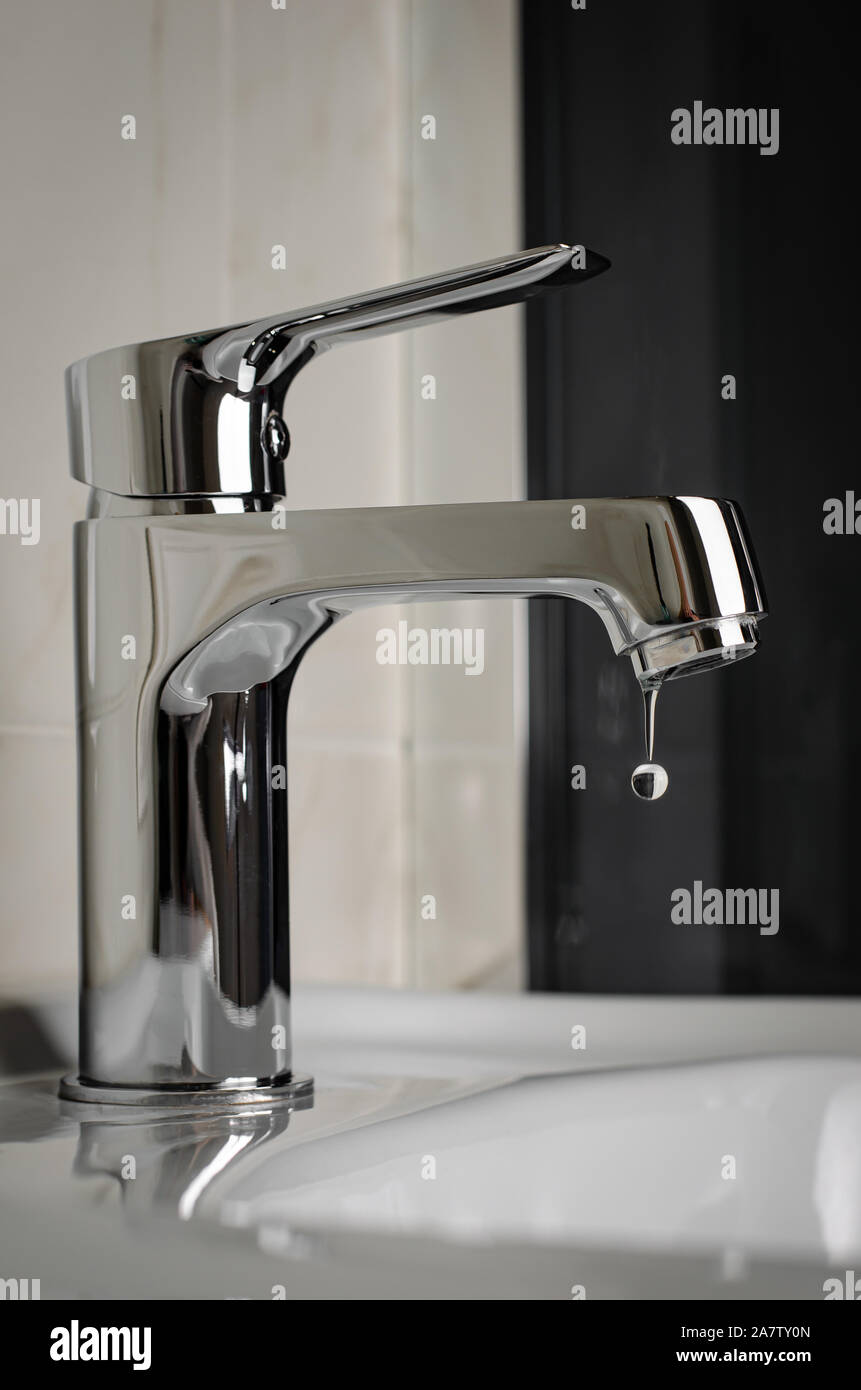Water tap, faucet dripping. Close up, vertical Stock Photo - Alamy