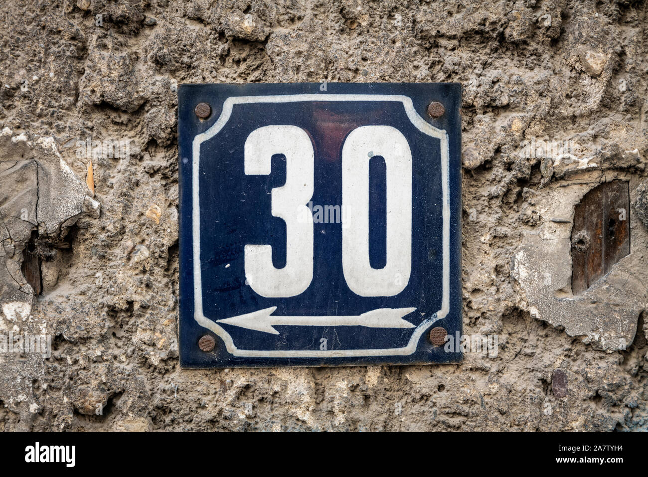 Street number sign on the wall Stock Photo - Alamy