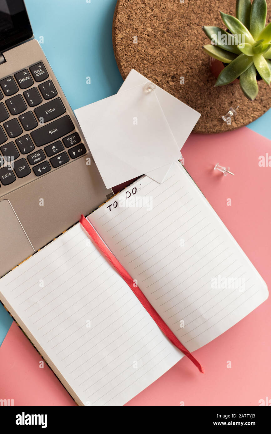 To do list on the background of laptop and potted plant. Working ...