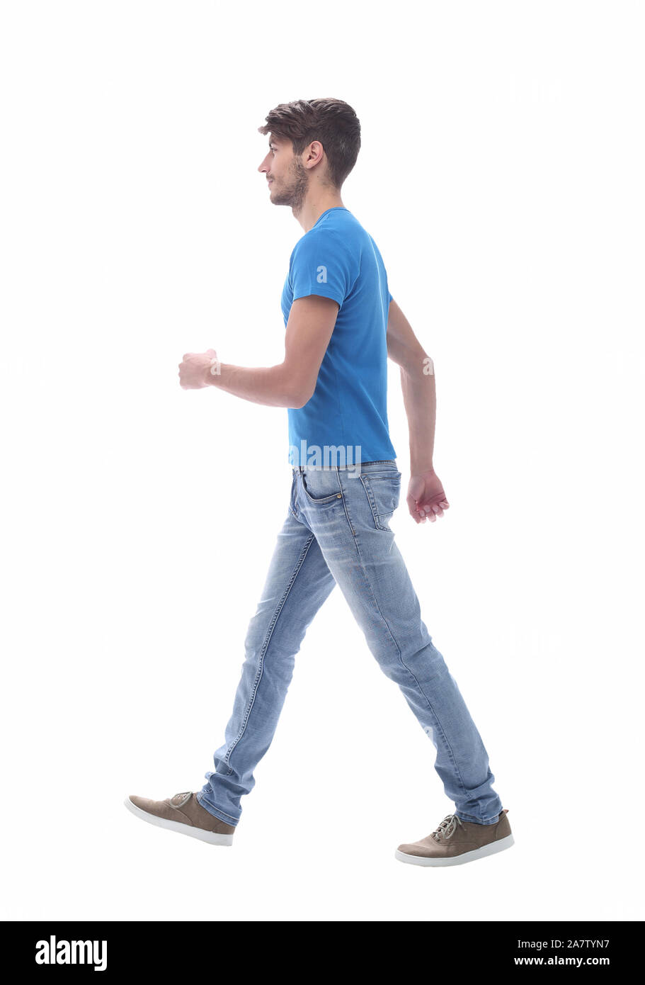 side view . smiling young man confidently stepping forward Stock Photo ...