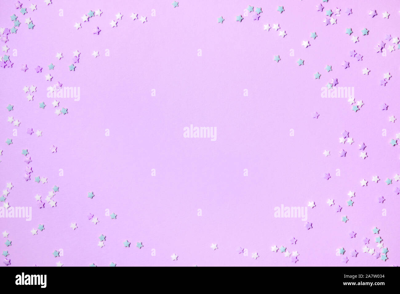 Little stars confetti on lilac background Stock Photo - Alamy