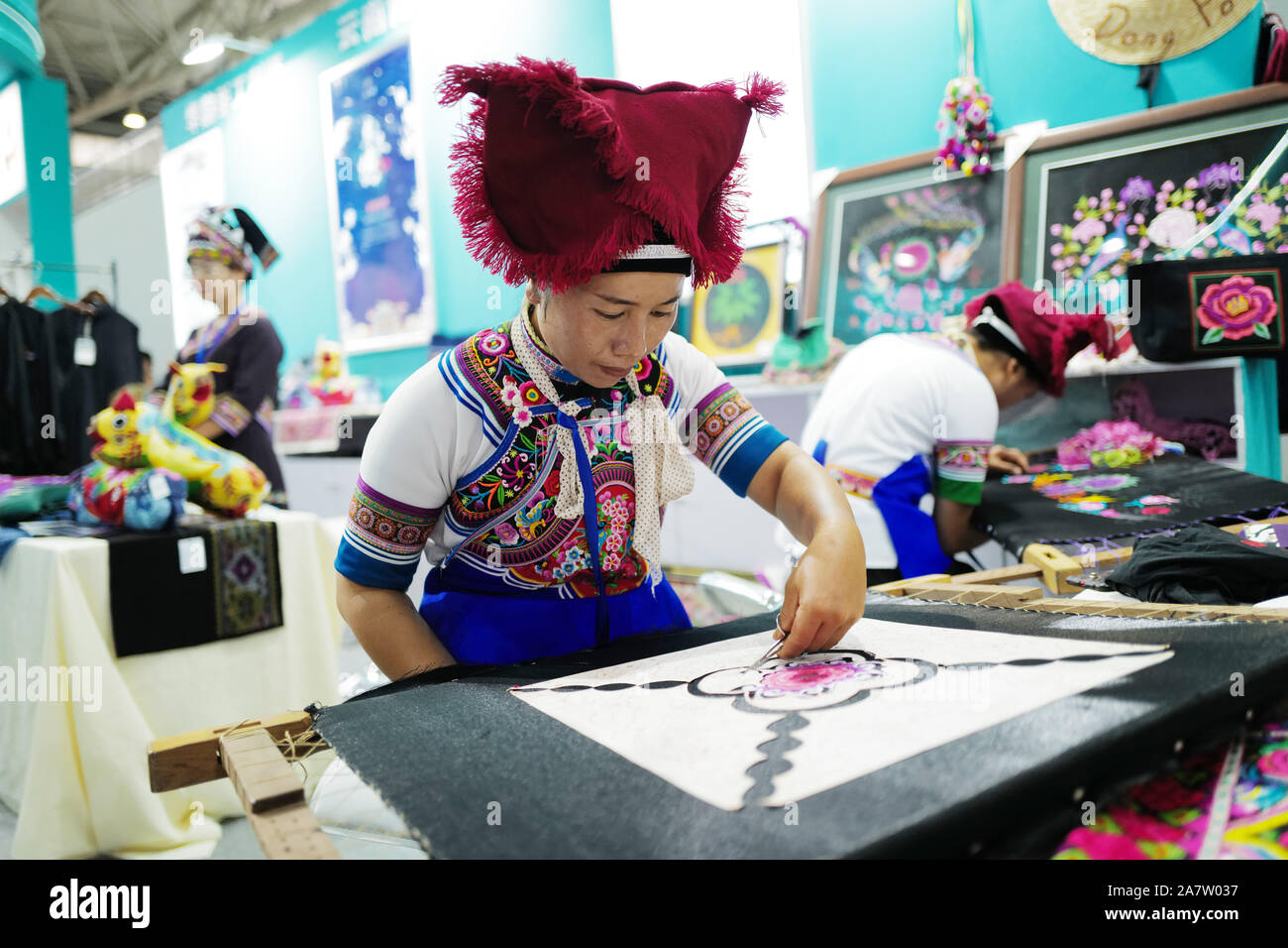 Chinese ethnic people dressed in traditional costumes perform during ...