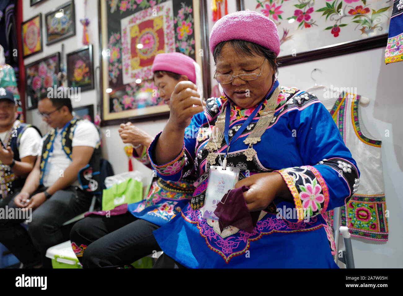 Chinese ethnic people dressed in traditional costumes perform during ...