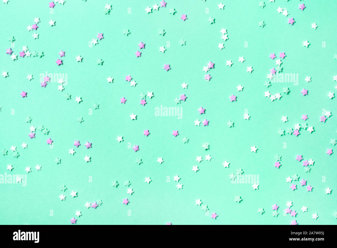 Little stars confetti on mint background Stock Photo - Alamy