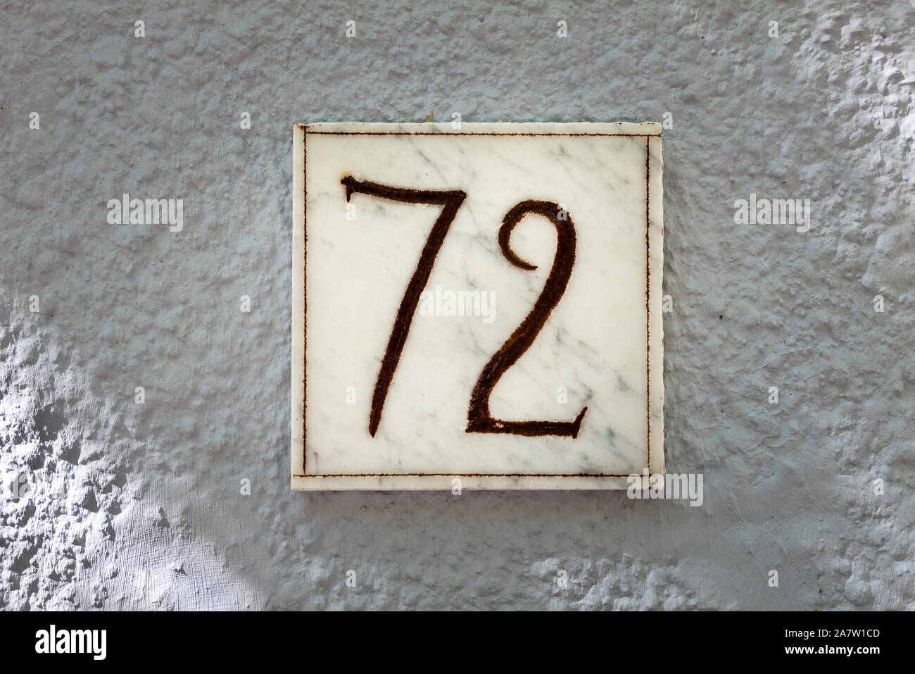 Street number sign on the wall Stock Photo - Alamy