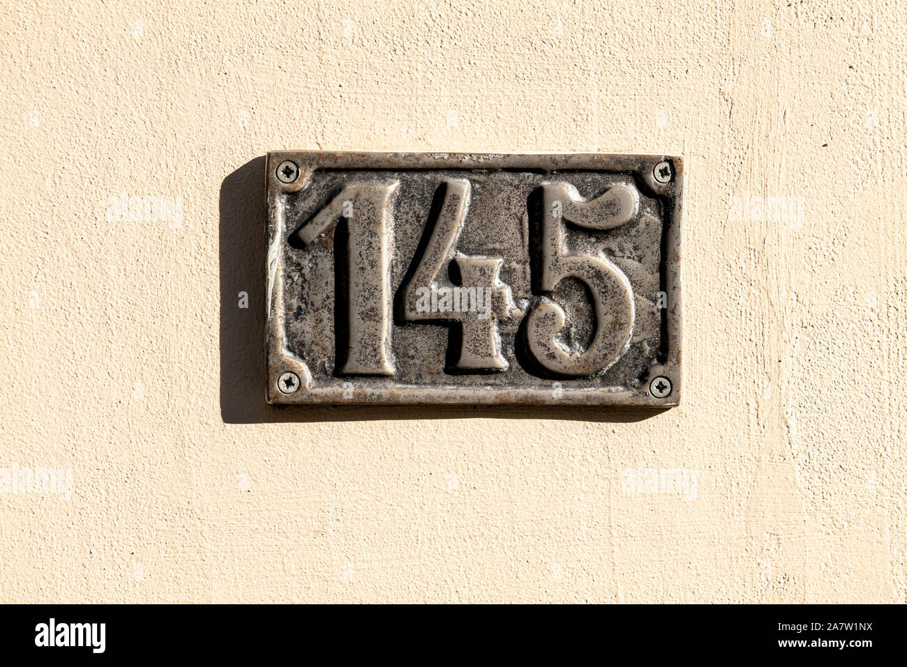 Street number sign on the wall Stock Photo - Alamy