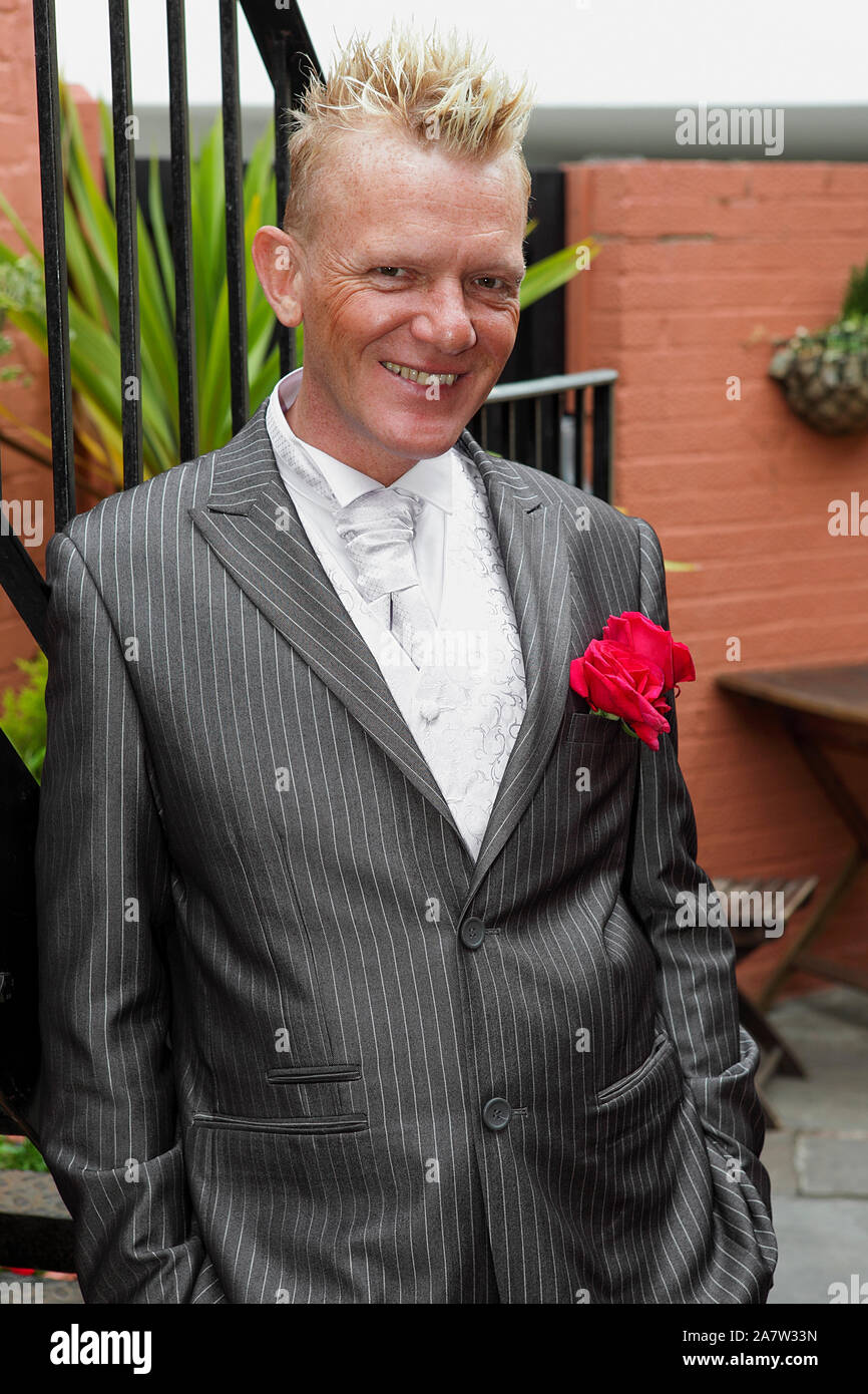 Tony, one half of the grooms poses with a smile during wedding ...