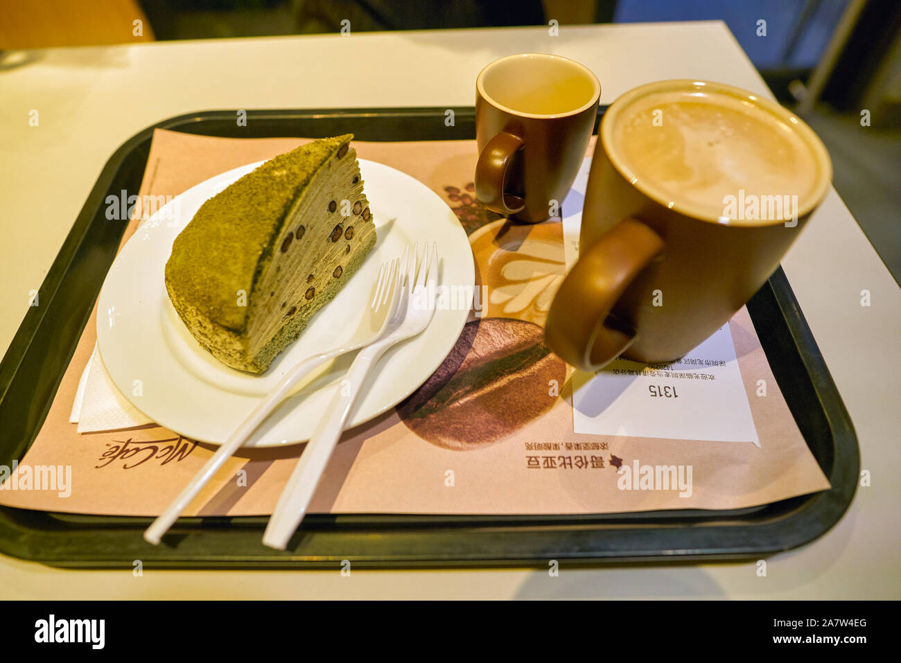 SHENZHEN, CHINA - CIRCA APRIL, 2019: coffee and cake served on a tray ...