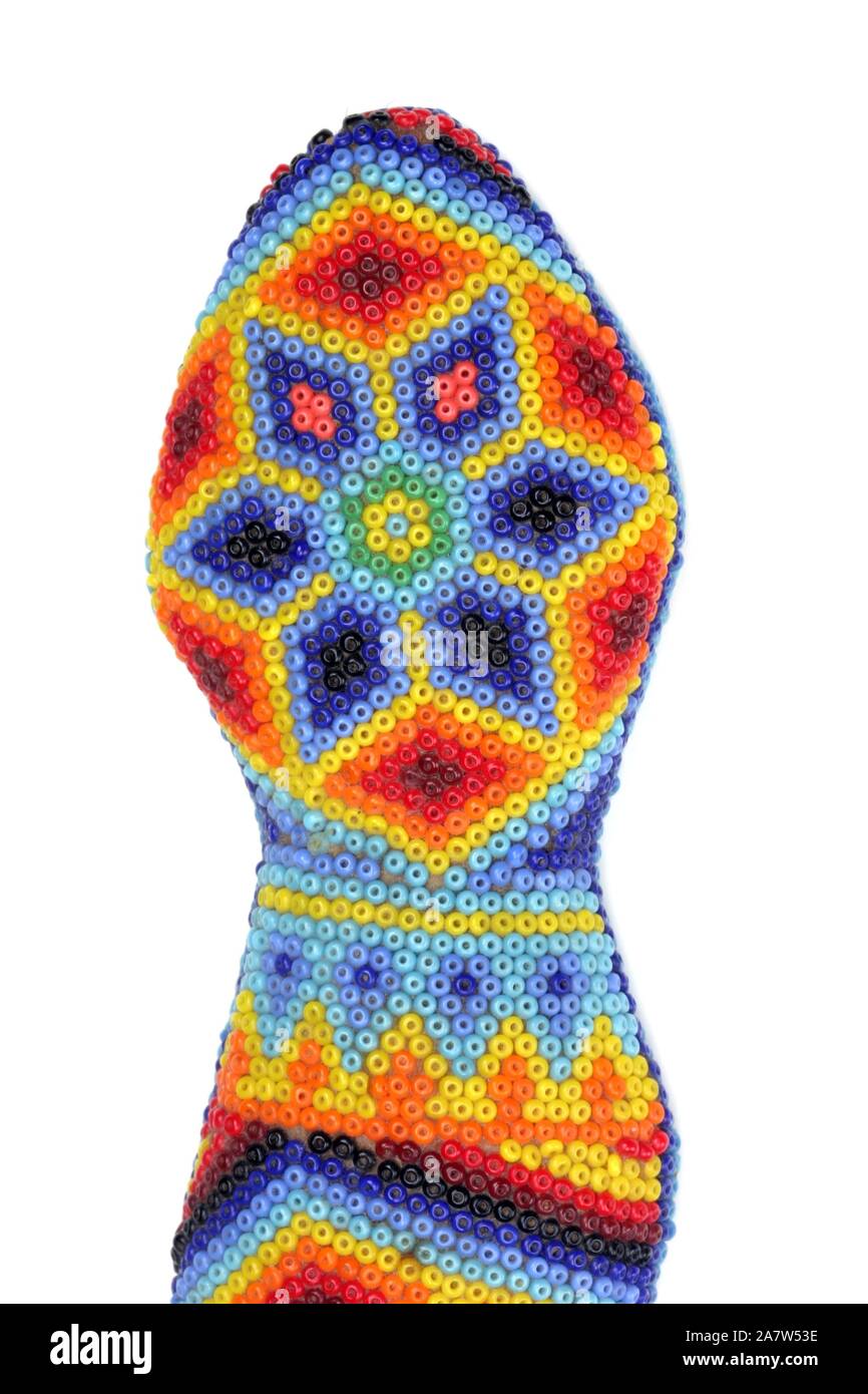 Close-up detail of the head of a beaded snake crafted by the Huichol ...