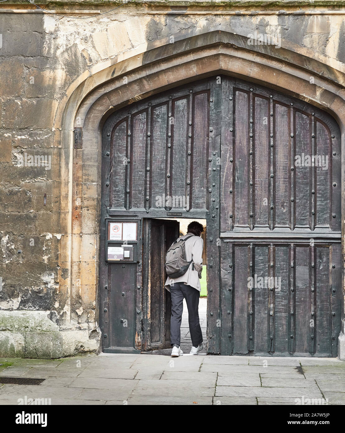A male student passes through the door to New college, university of ...