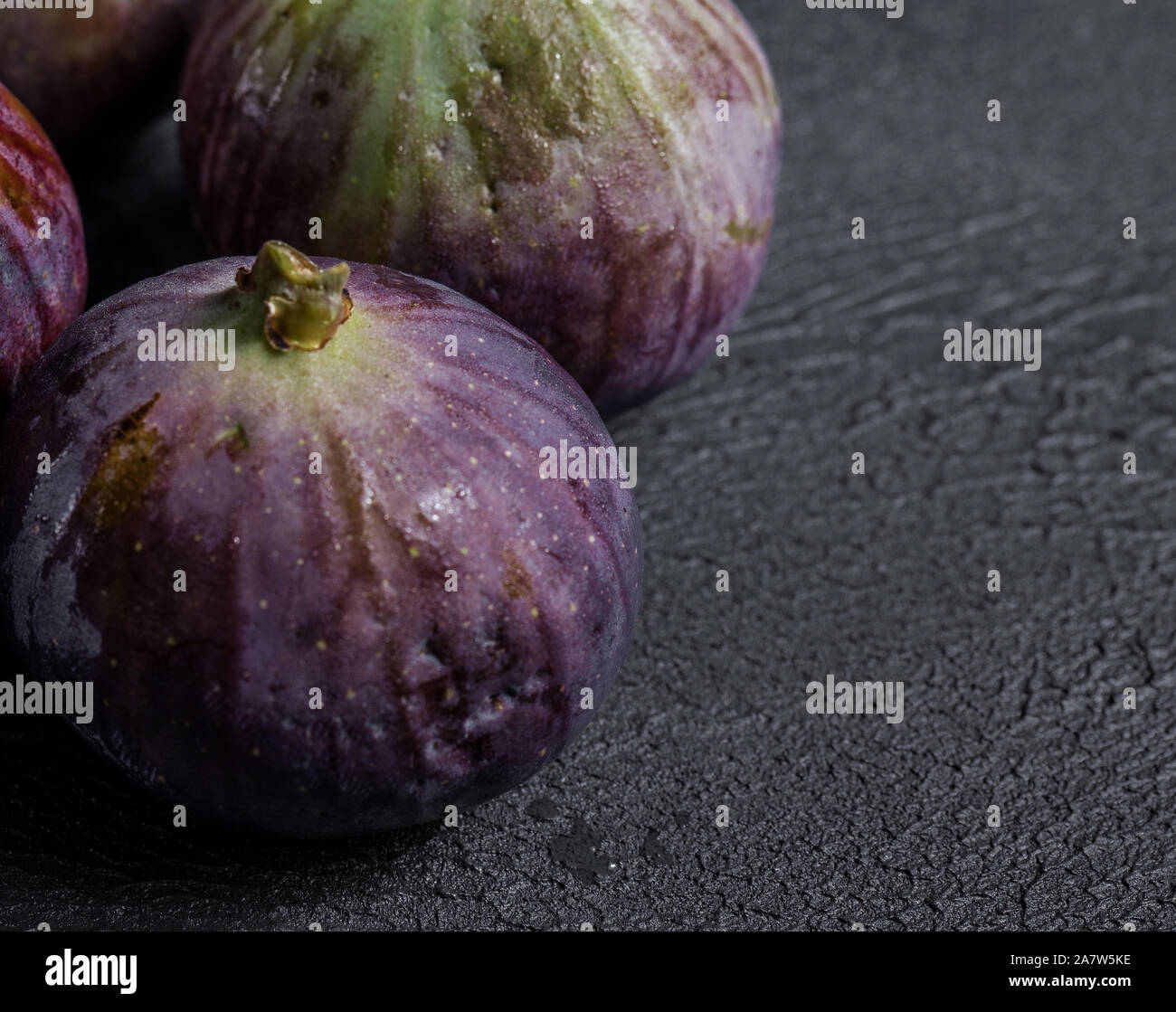 fresh figs close-up on black background. dark moody photo Stock Photo ...