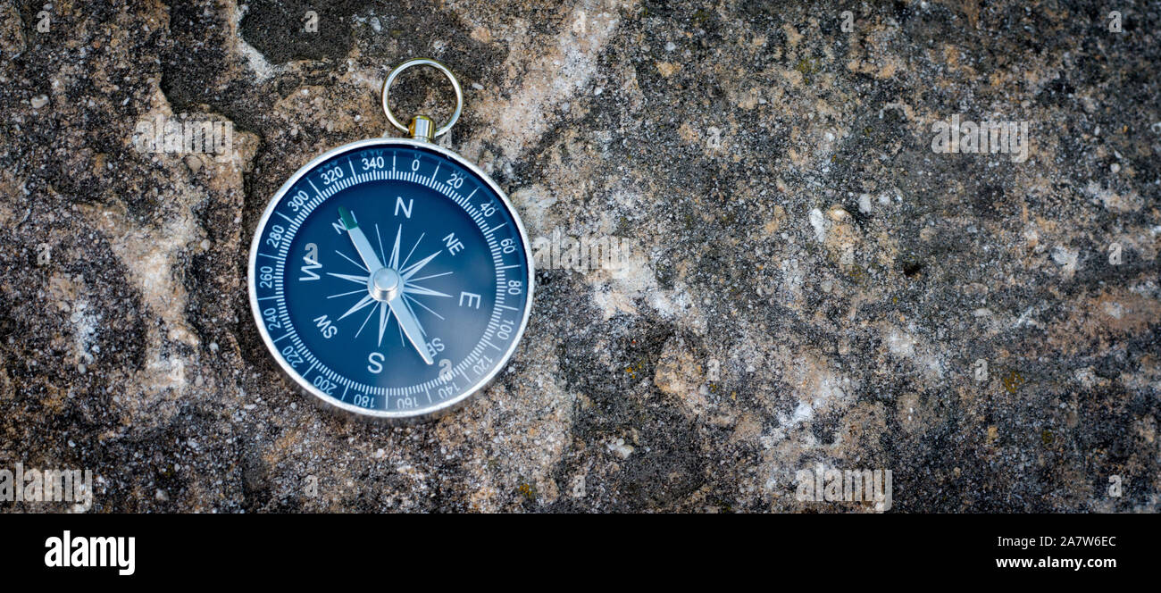 Vintage compass lying on the floor. Adventure and discovery concept ...