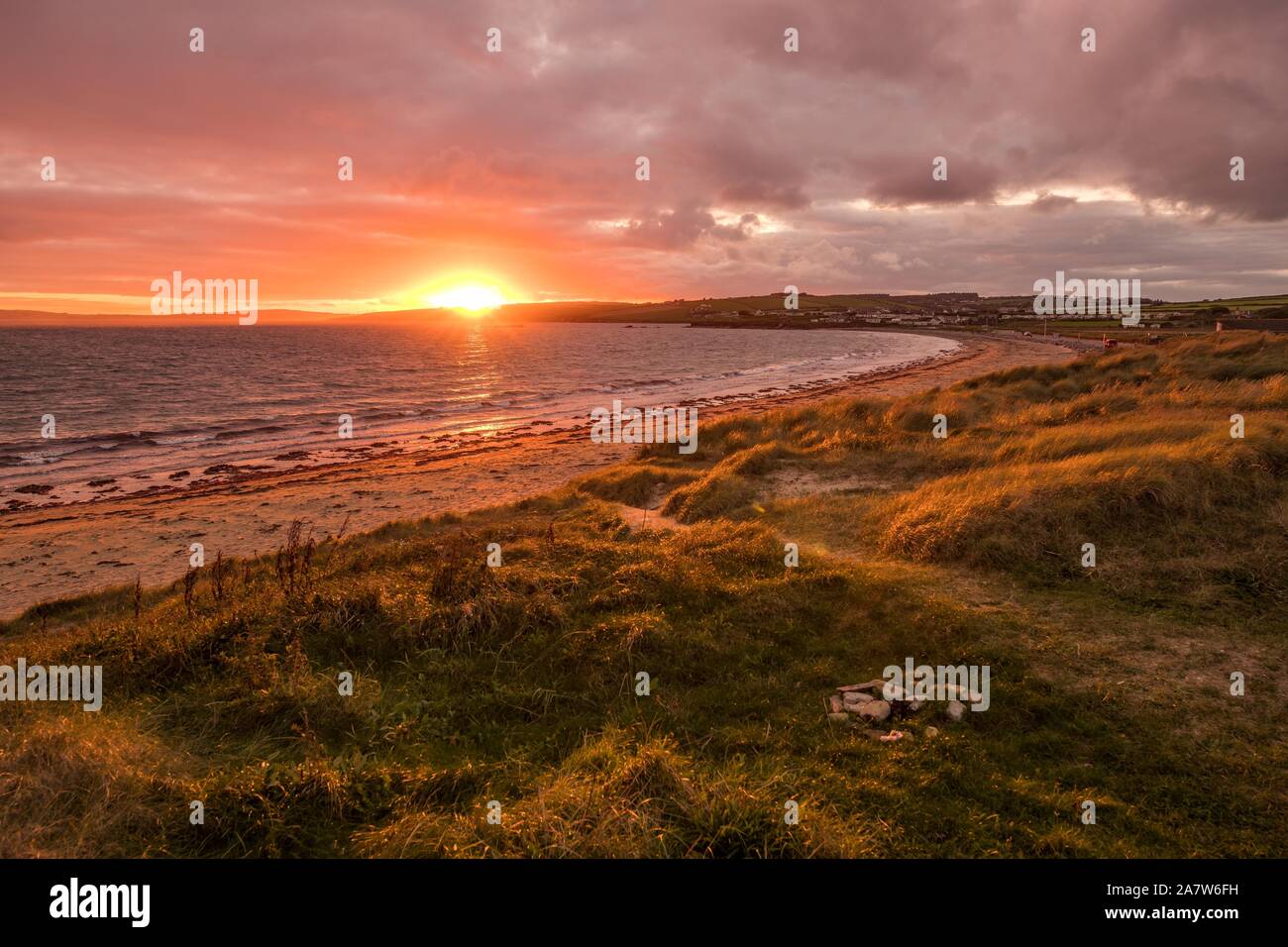 Sunset and clouds at beach in south Ireland Stock Photo - Alamy