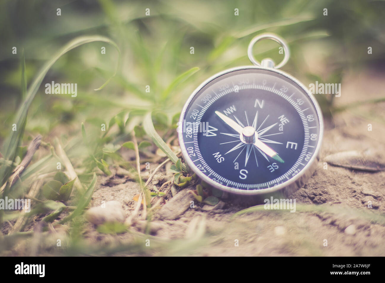 Vintage compass lying on the floor. Adventure and discovery concept ...