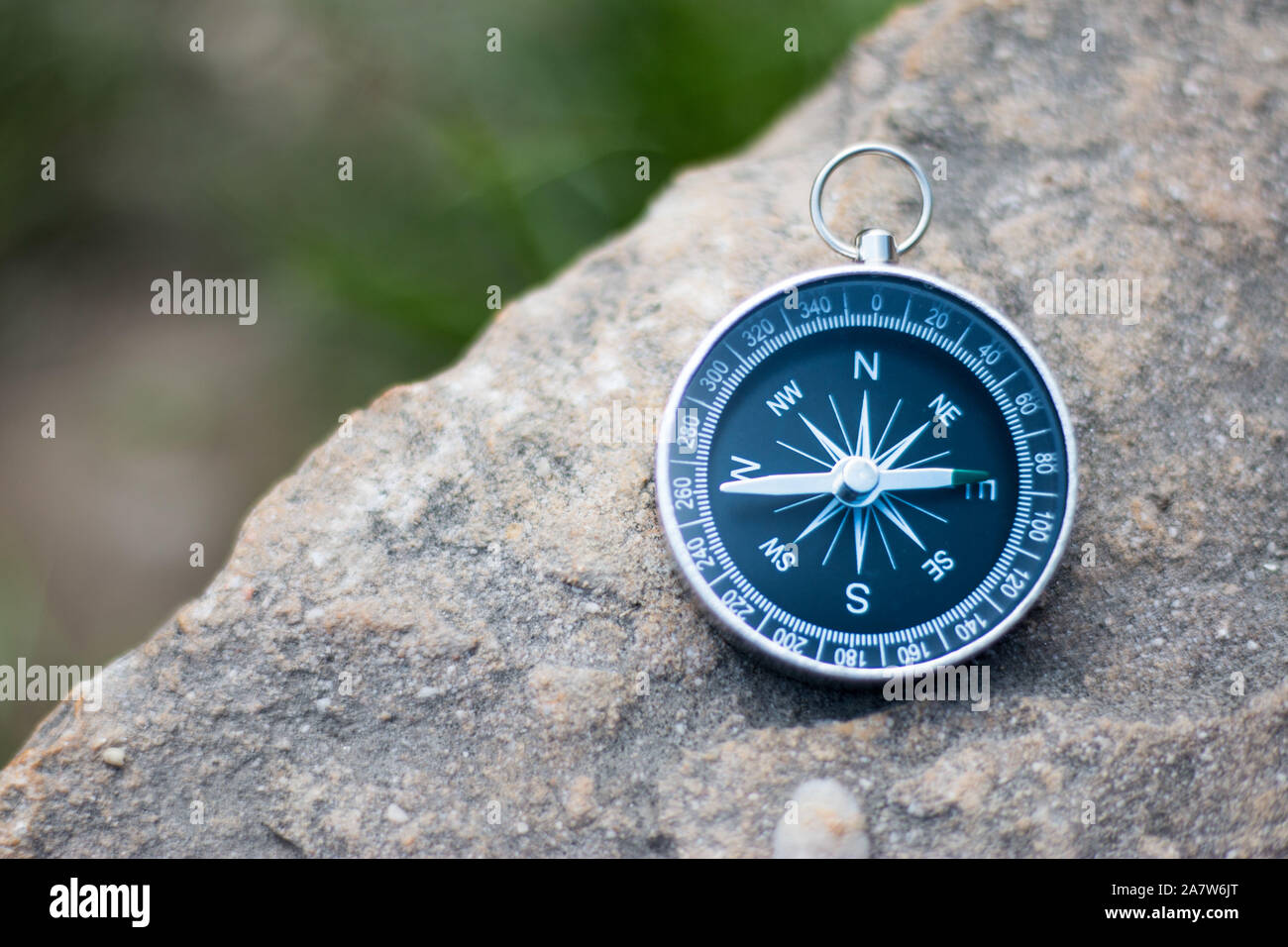 Vintage compass lying on the floor. Adventure and discovery concept ...