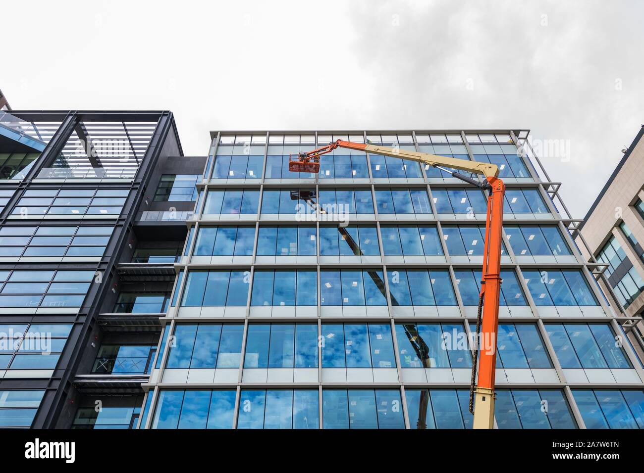 Washing windows on a high-rise building using a high-lift platform ...