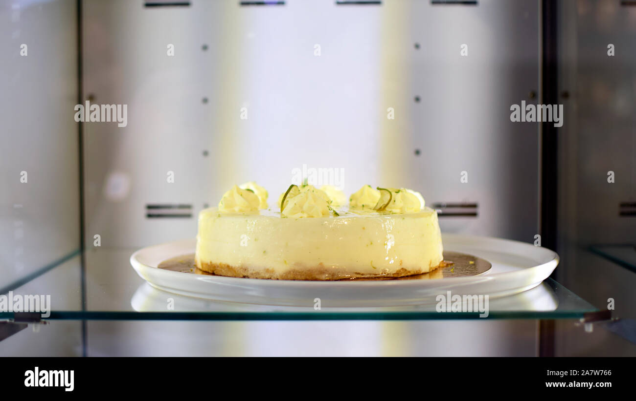 Delicious cheese-cake with whipped cream at bakery display Stock Photo ...