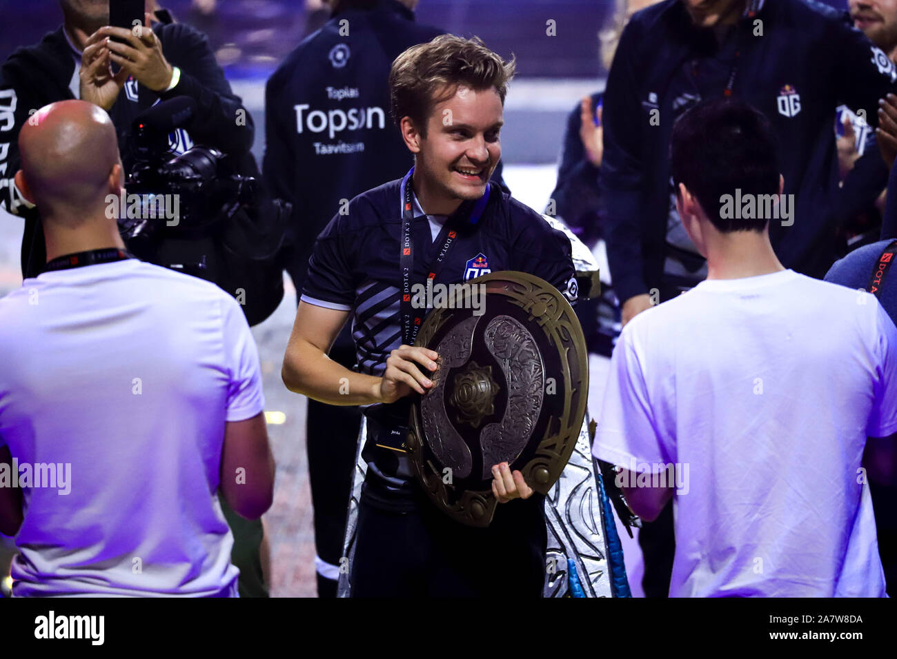 Players of Europe's OG pose for photos with their trophy after winning ...