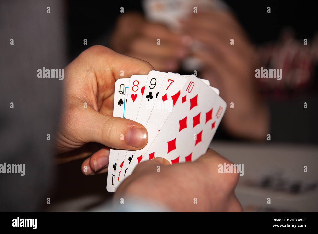 combination of four different play cards in a hand Stock Photo - Alamy