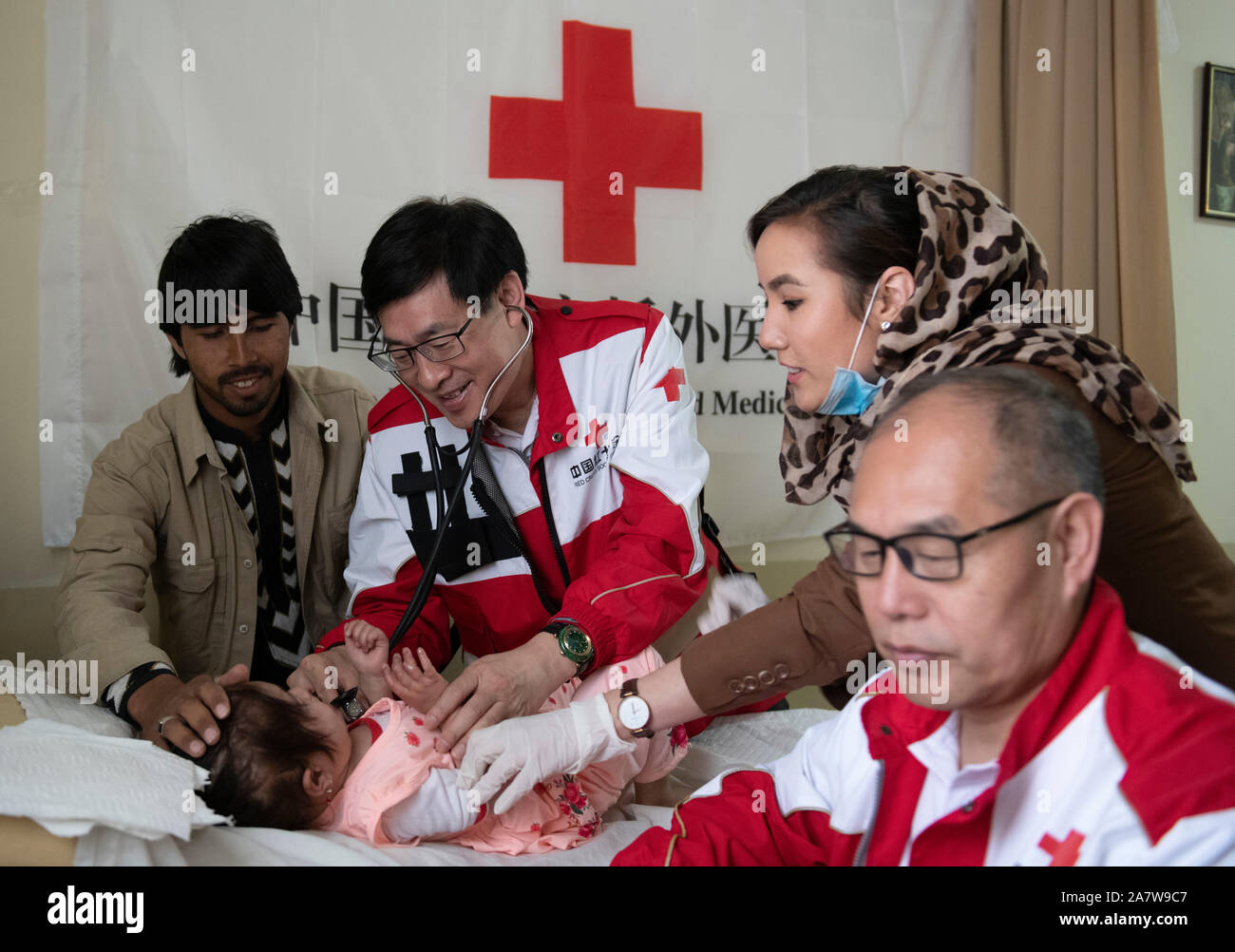 Chinese doctors from Red Cross Society of China examine an Afghan child ...