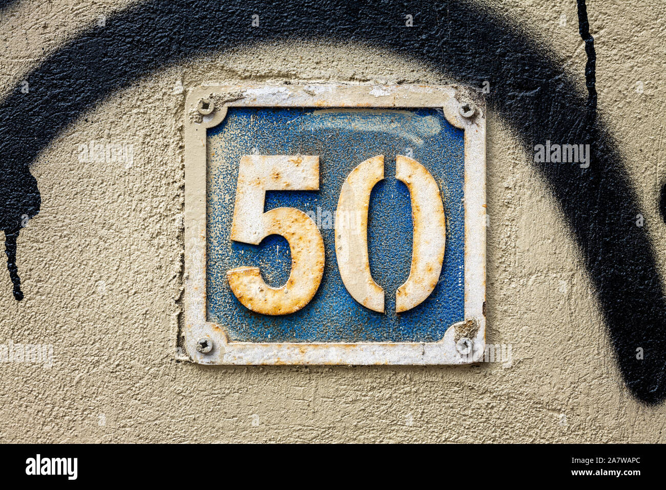 Street number sign on the wall Stock Photo - Alamy