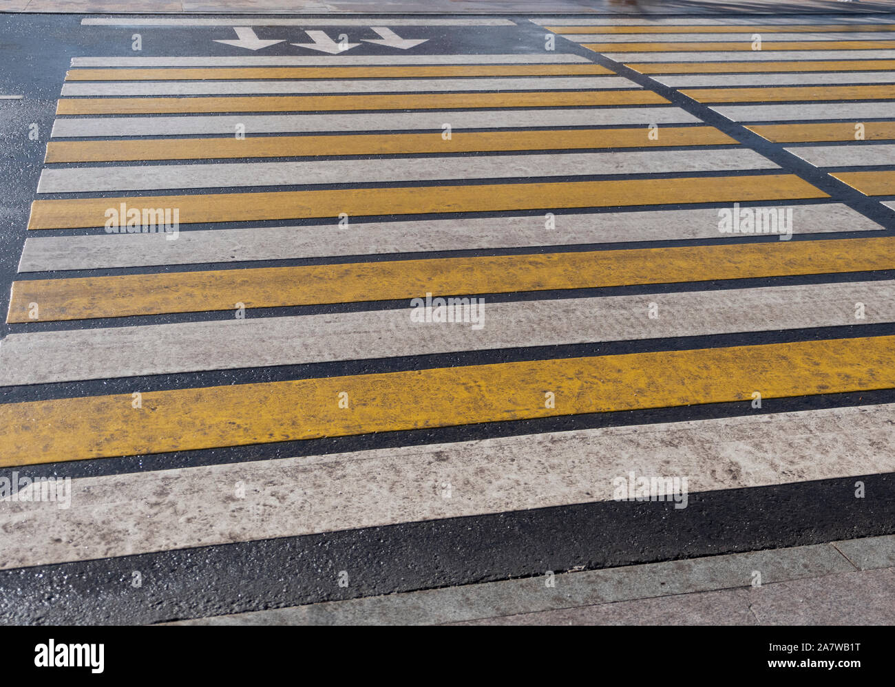 Bright yellow and white stripes of zebra crossing, pedestrian crosswalk ...