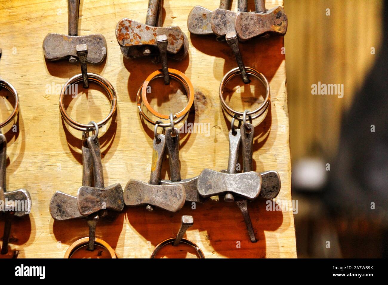 Ax-shaped forged metal keychains for sale at a medieval street market ...