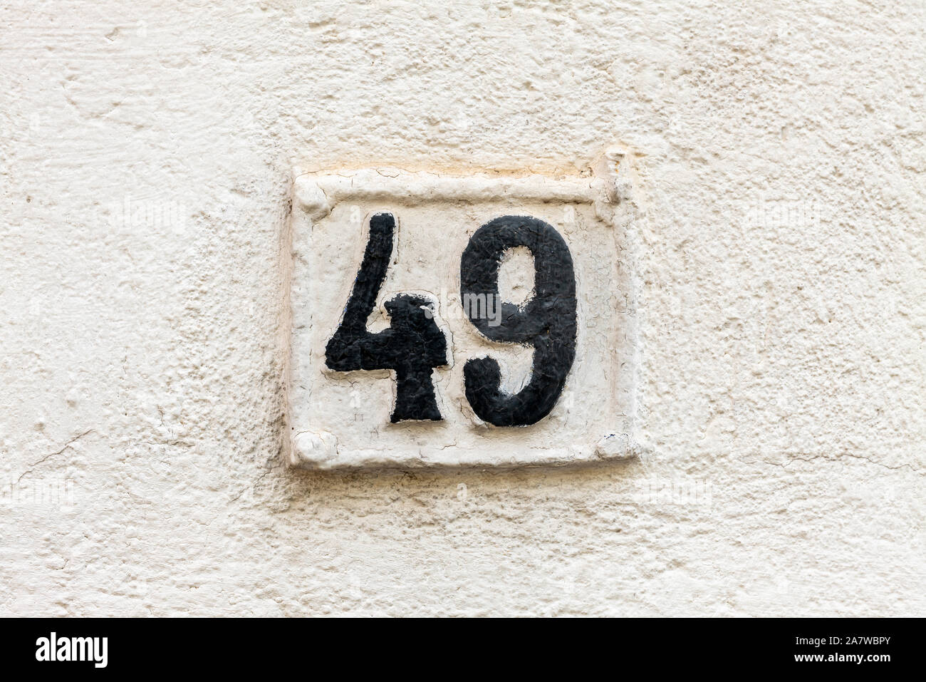 Street number sign on the wall Stock Photo - Alamy