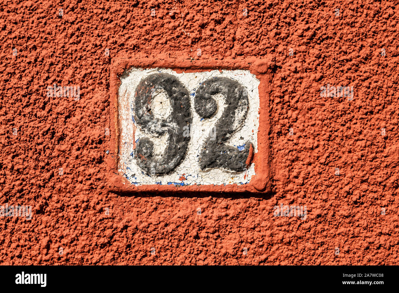 Street number sign on the wall Stock Photo - Alamy