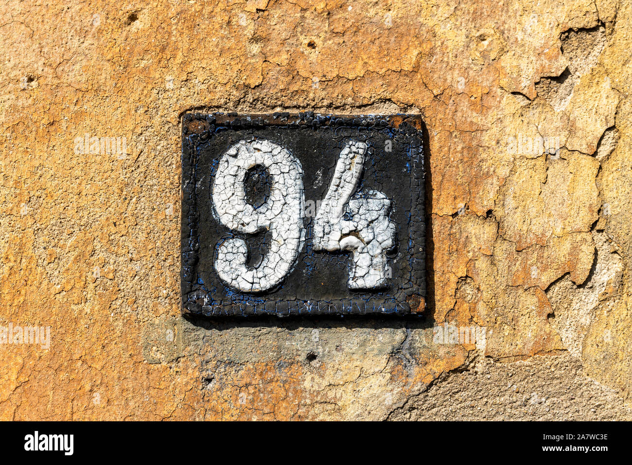 Street number sign on the wall Stock Photo - Alamy