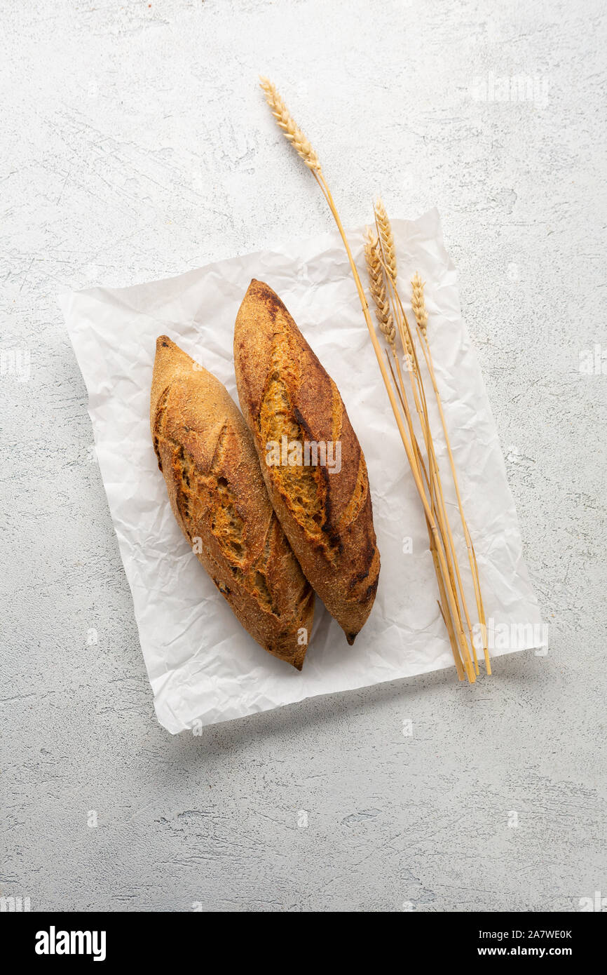 Two loaf of bread top view on white background and wheats Stock Photo ...