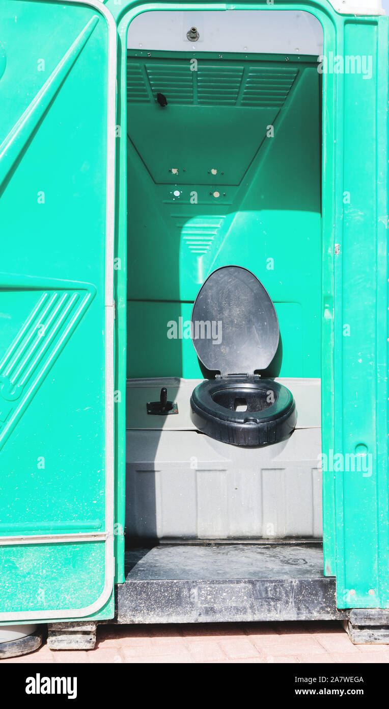 Open cabin of plastic portable toilets at an outdoor in park. The ...