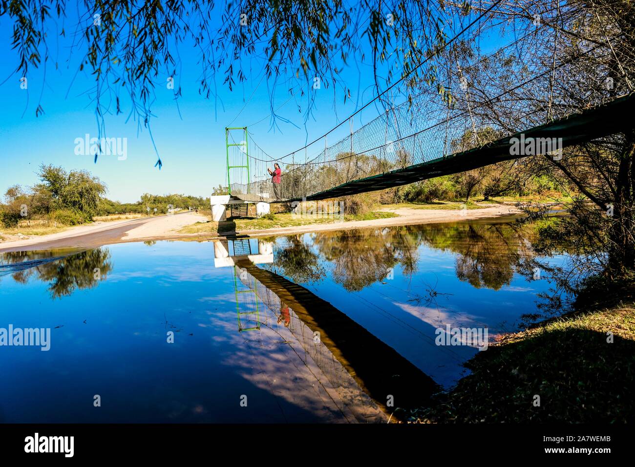 Suspension bridge over the Sonora river water flow as it passes through ...