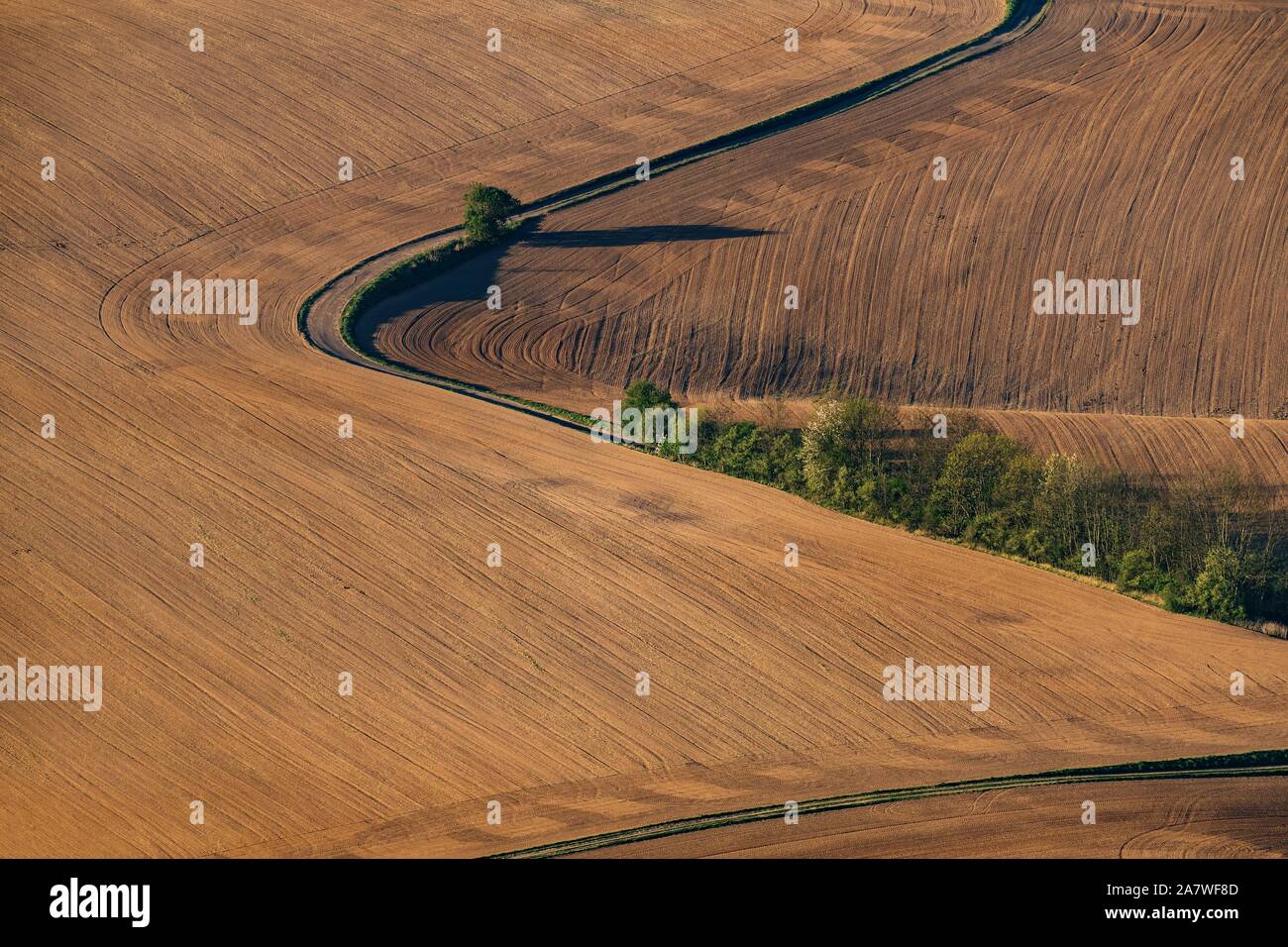 Road winding through spring fields on aerial photo Stock Photo - Alamy
