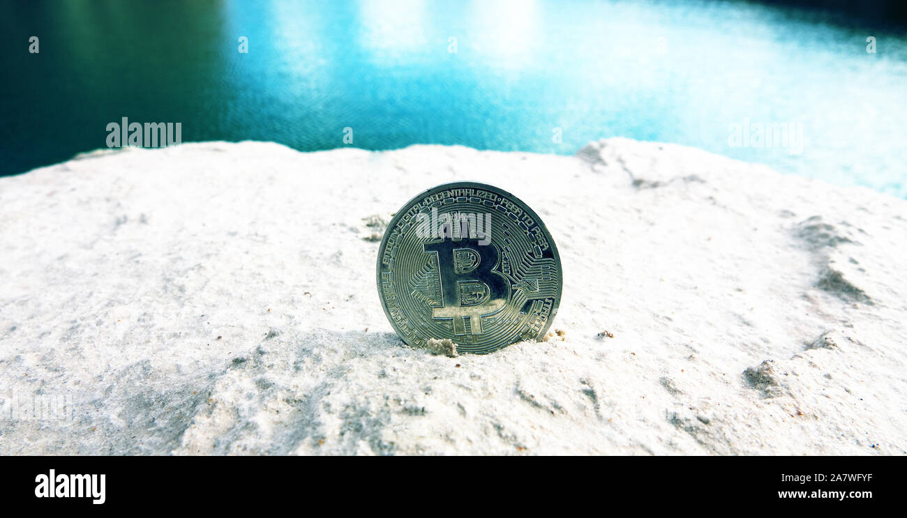 Bitcoin visualization on ocean on a tropical beach. Expensive coin and ...