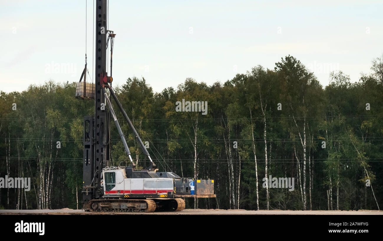 Construction of the highway. pile driving engine Stock Photo - Alamy