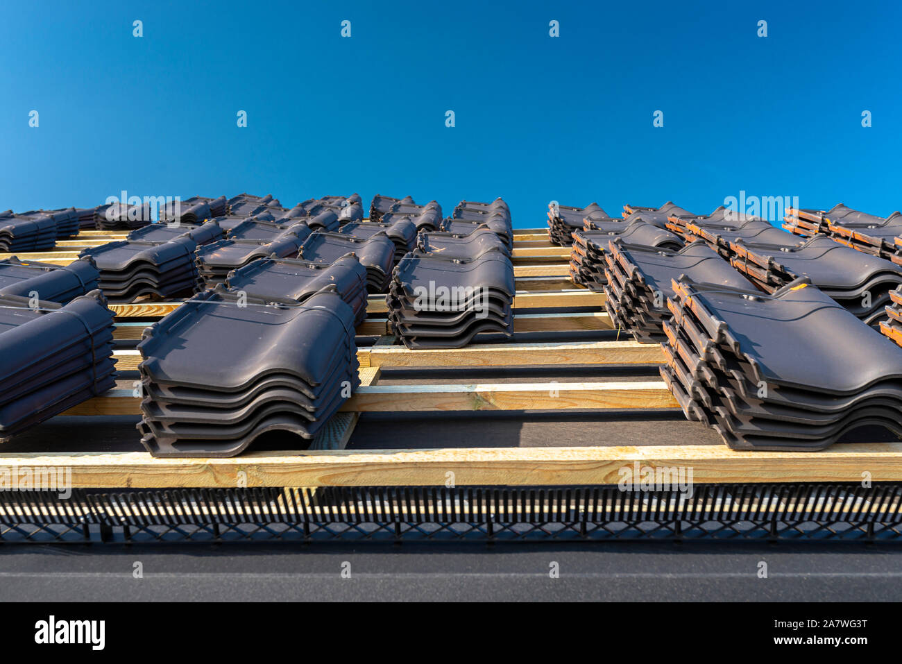 Roof ceramic tile arranged in packets on the roof on roof battens ...