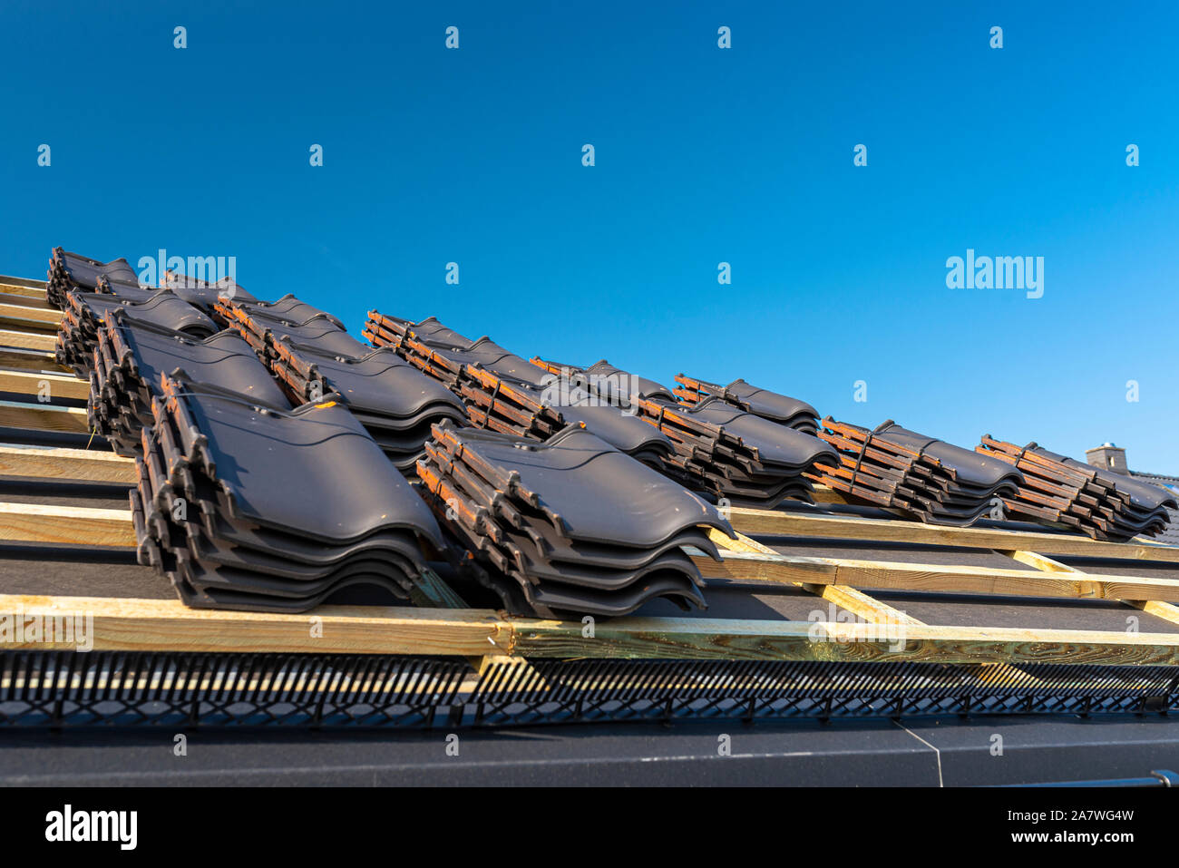 Roof ceramic tile arranged in packets on the roof on roof battens ...