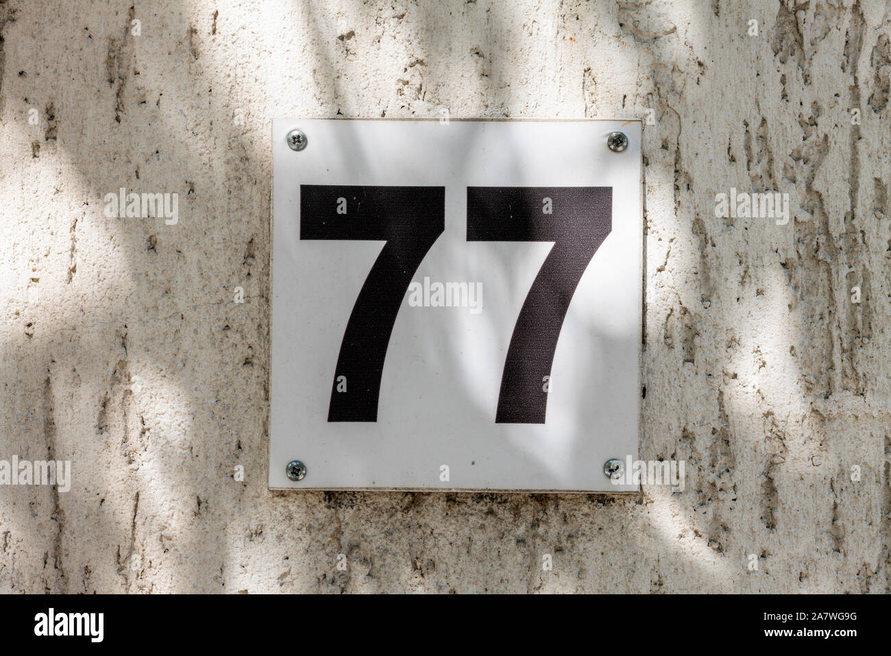Street number sign on the wall Stock Photo - Alamy
