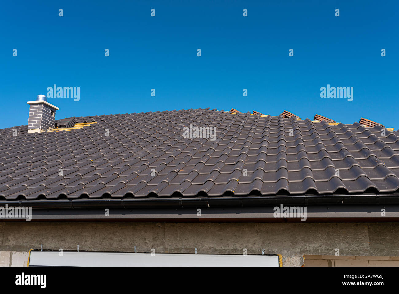 The roof of a single-family house covered with a new ceramic tile in ...