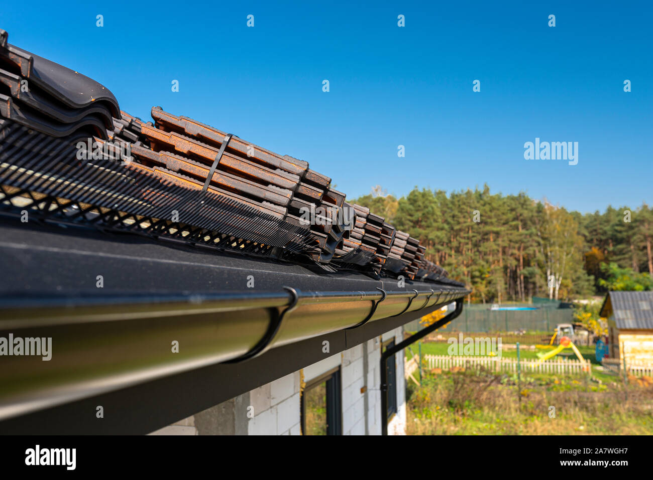 Roof ceramic tile arranged in packets on the roof on roof battens ...