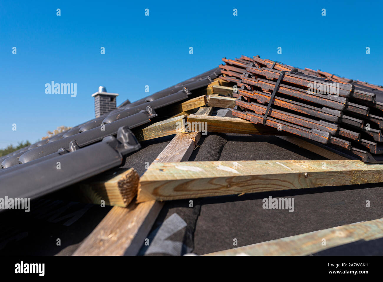 Roof ceramic tile arranged in packets on the roof on roof battens ...
