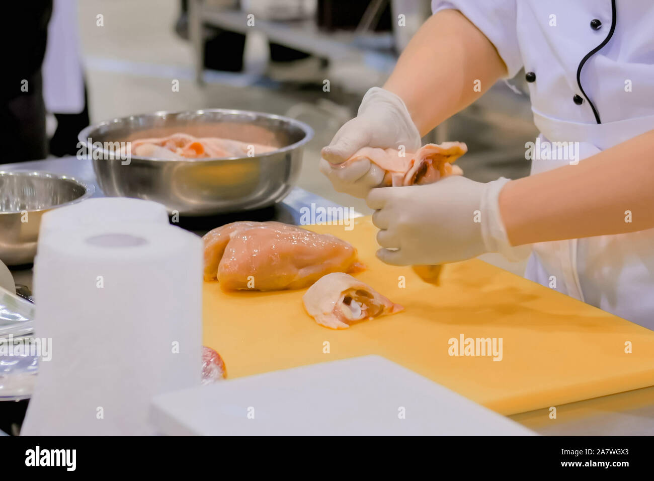 Cook cutting chicken meat with knife Stock Photo - Alamy