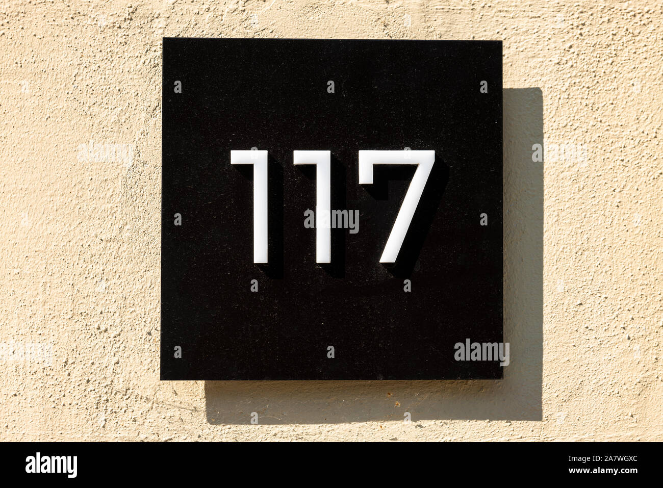 Street number sign on the wall Stock Photo - Alamy