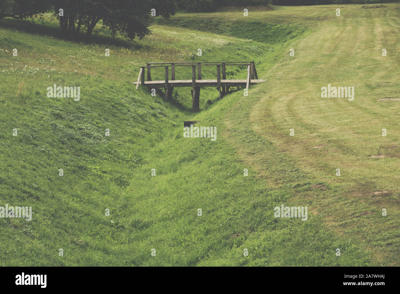 small wooden bridge over a drainage ditch Stock Photo - Alamy
