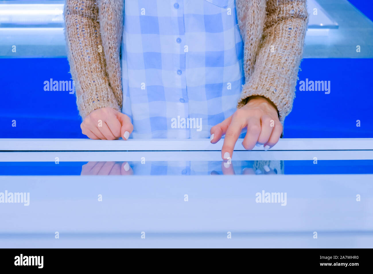 Woman using multimedia touchscreen display of interactive kiosk Stock ...
