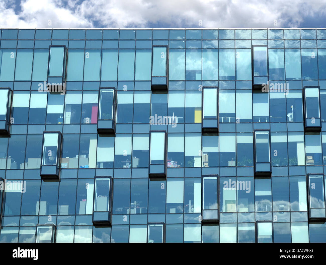 Facade with glass wall of modern office building with many large ...