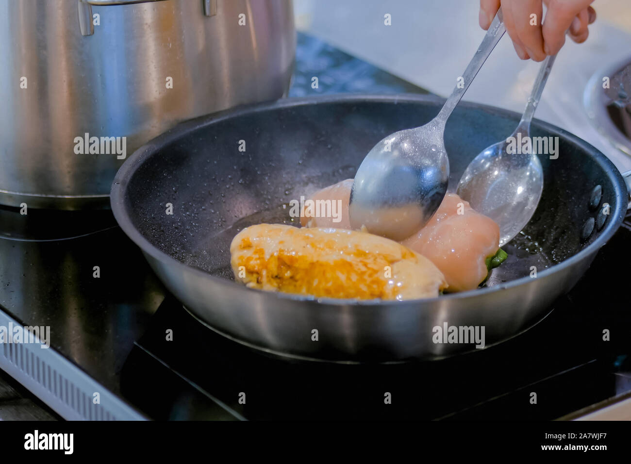 Chicken rolls with herbs frying in pan Stock Photo - Alamy