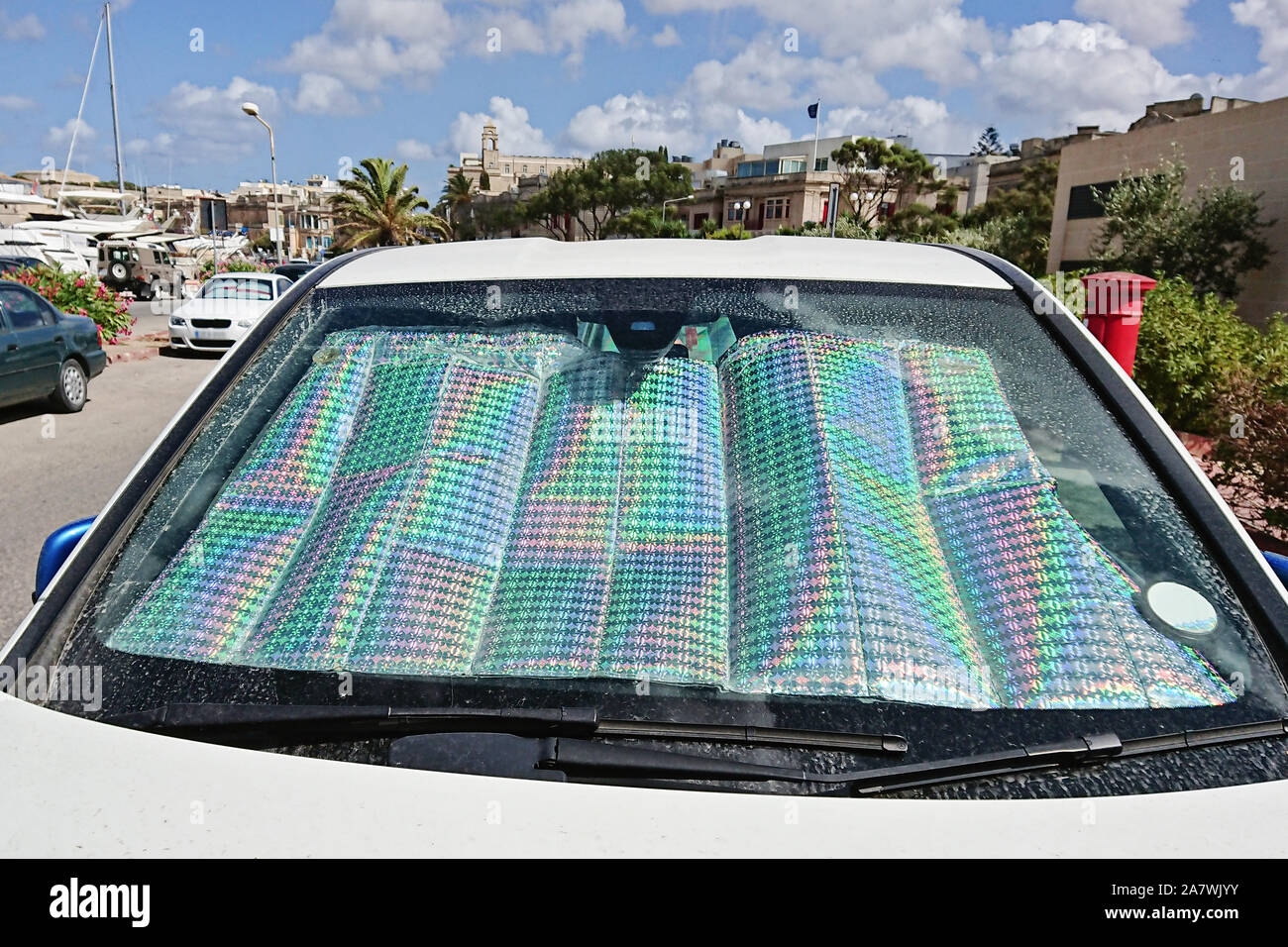 Windshield of car with protective reflective sunscreen surface inside ...